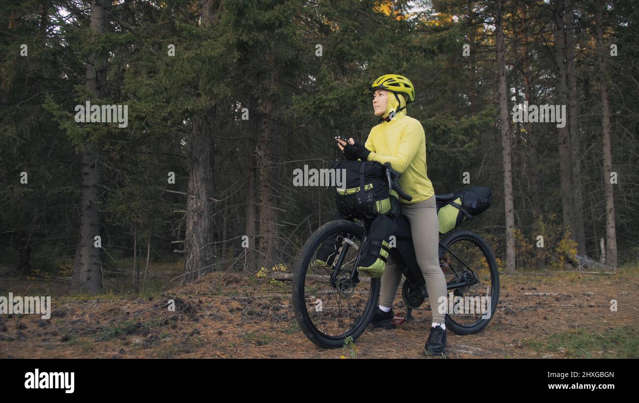 The woman travel on mixed terrain cycle touring with bike bikepacking ...