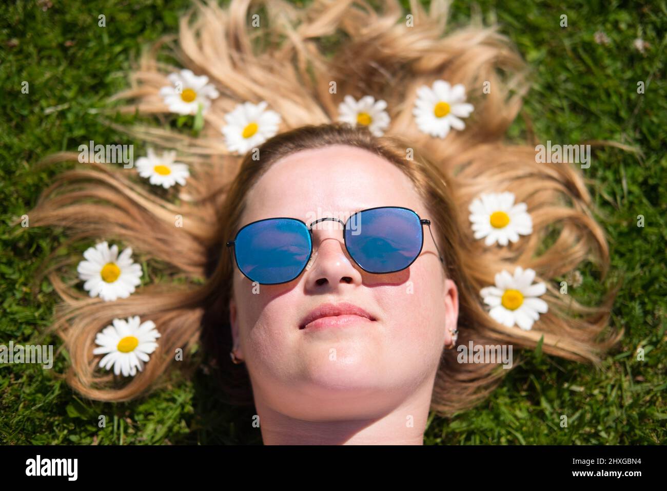 The Portrait Of Beautiful Woman In Sunglasses Lying In The Field With