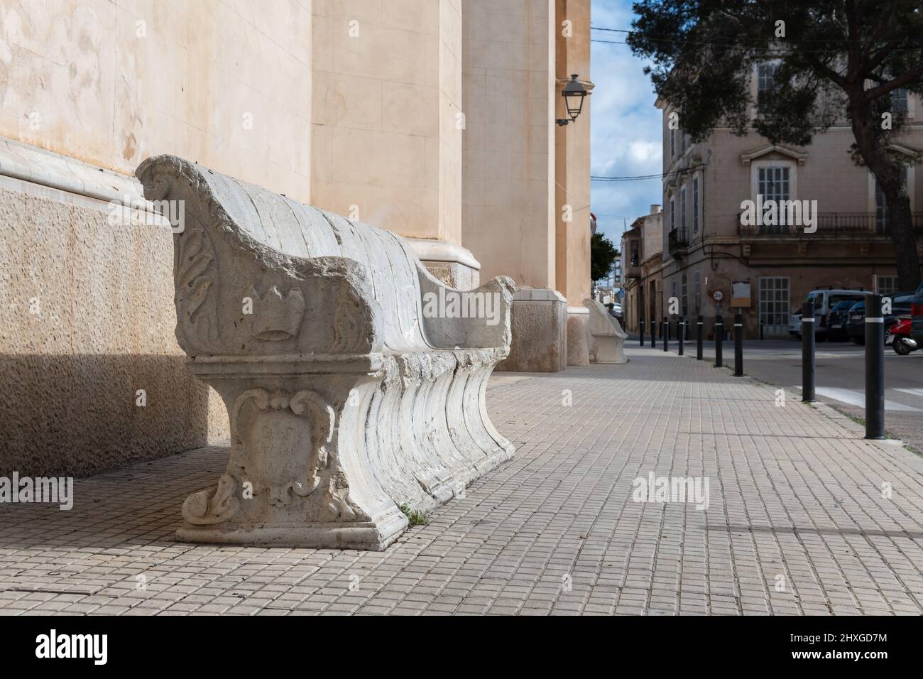 Old deteriorated white stone bench at the entrance of the convent of ...