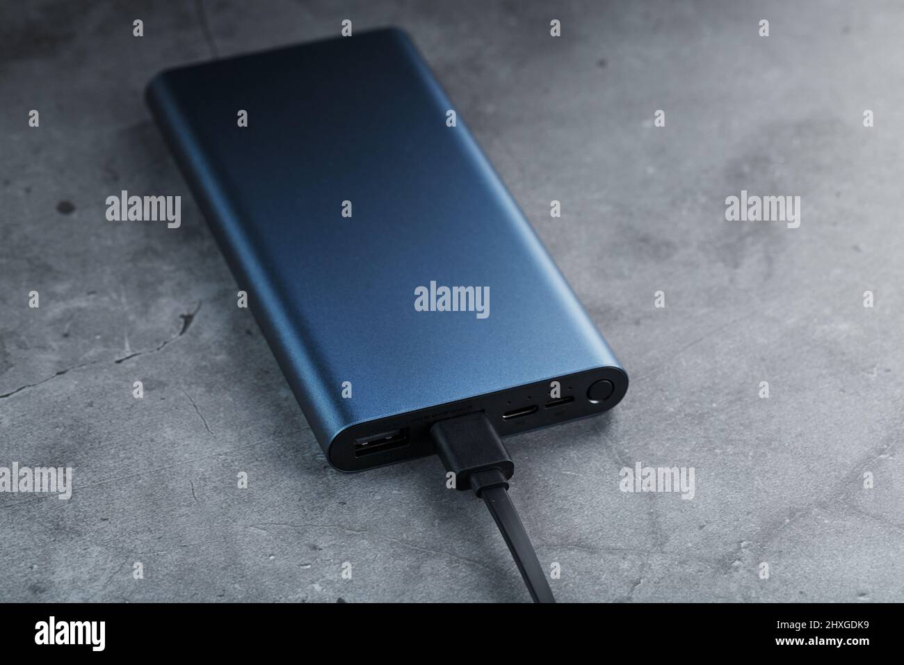 Portable External Battery Power Bank blue with USB Cord on a dark ...