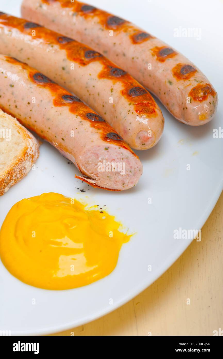 traditional fresh German wurstel sausages grilled with yellow mustard ...