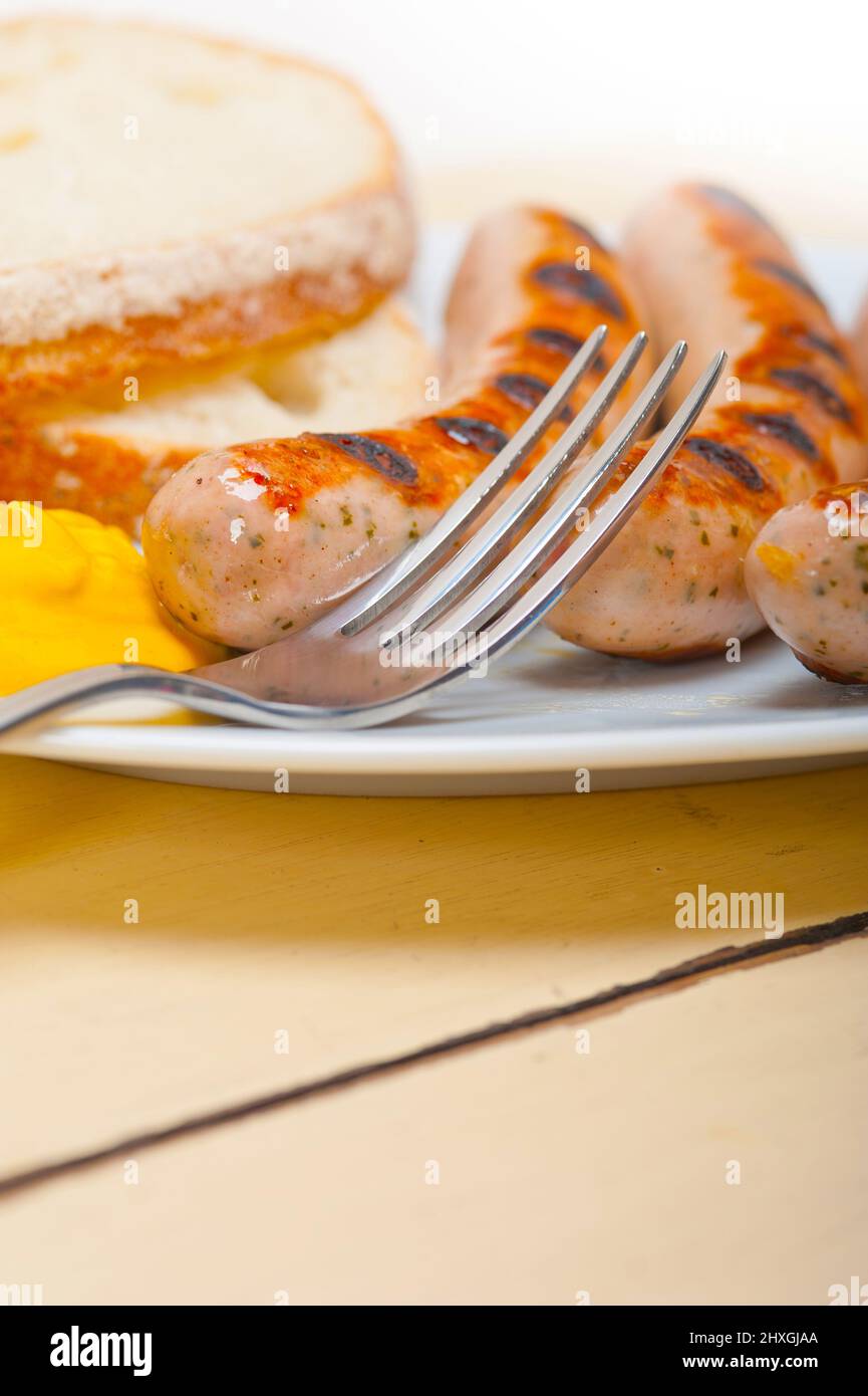 traditional fresh German wurstel sausages grilled with yellow mustard ...