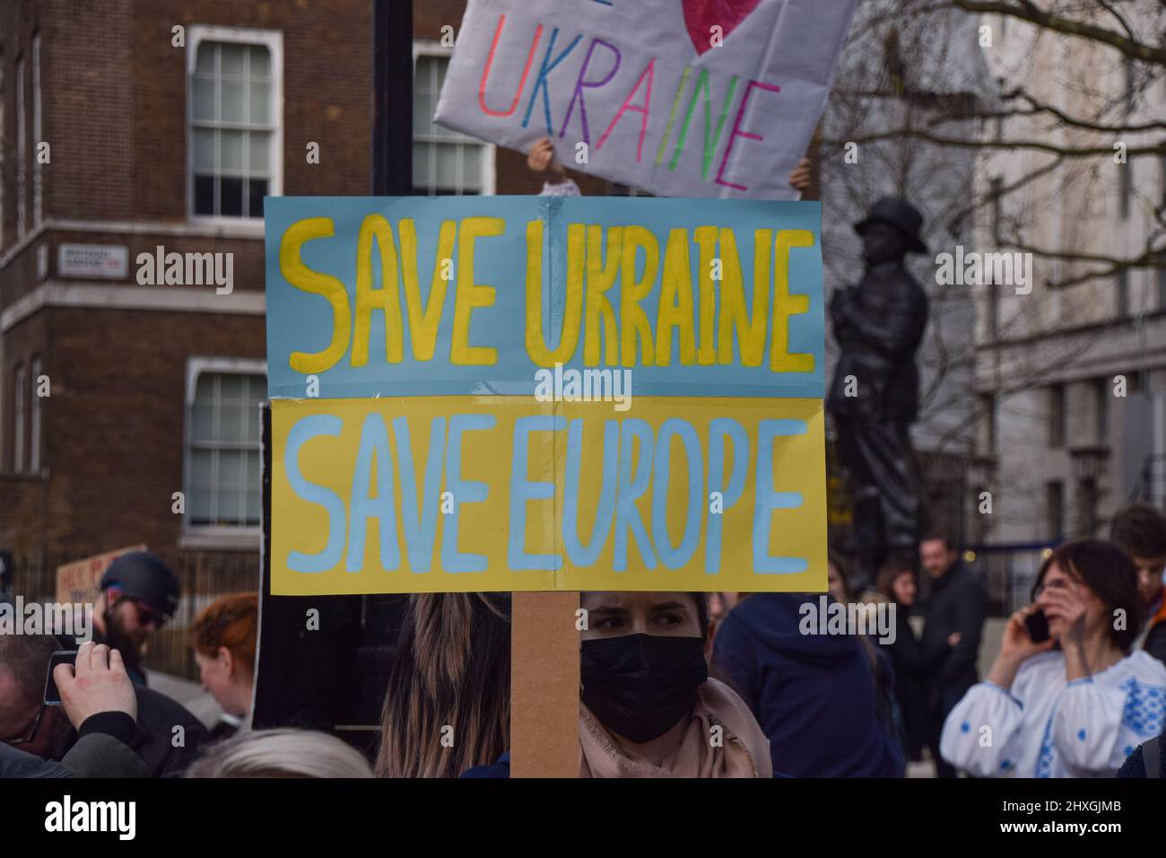 London, UK. 12th March 2022. A protester holds a 'Save Ukraine Save ...