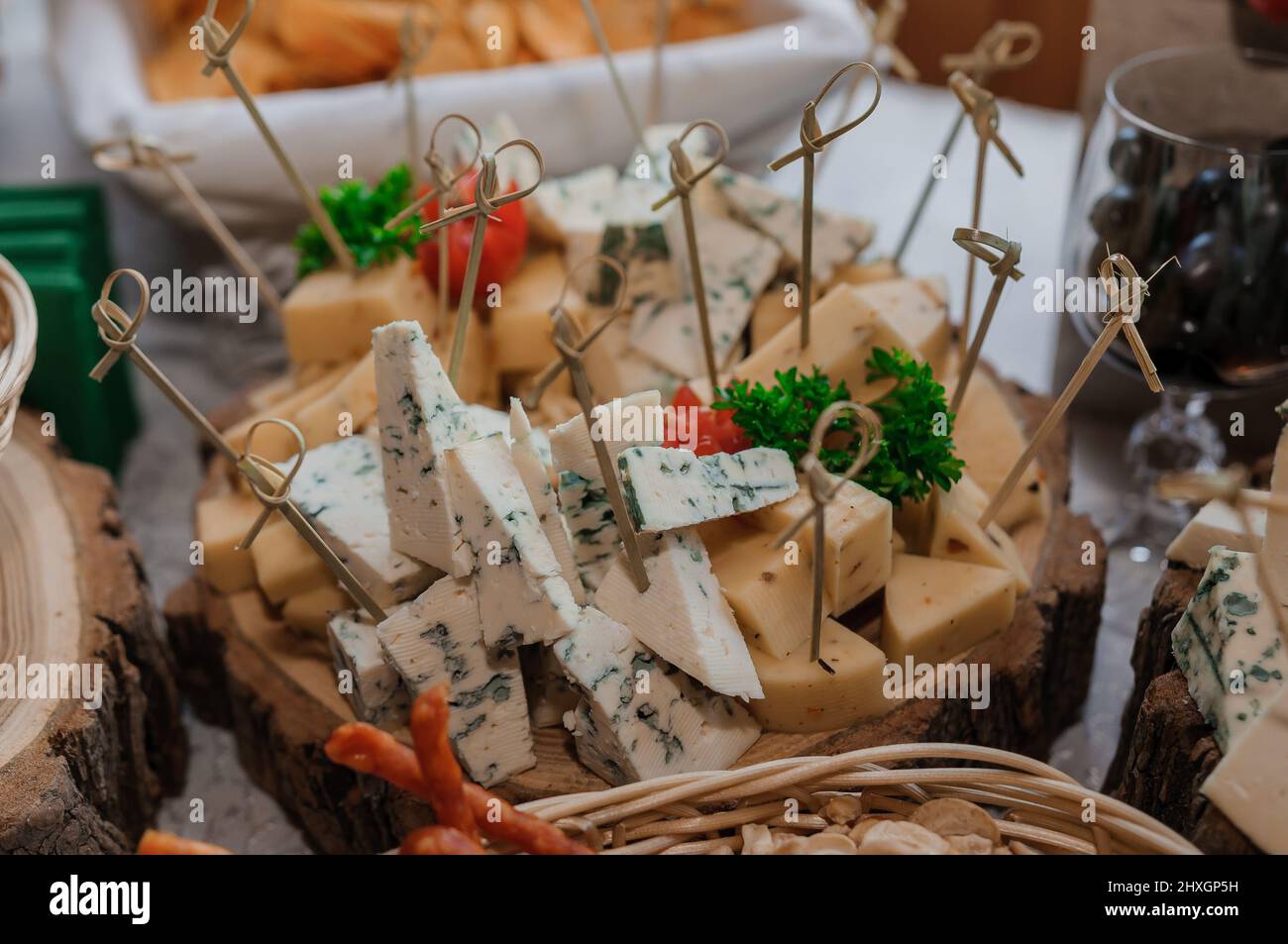 Wedding buffet. Slicing different types of cheese Stock Photo - Alamy