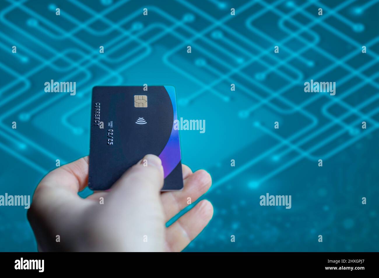 Hand holding debit card. Technology background, e-commerce concept ...