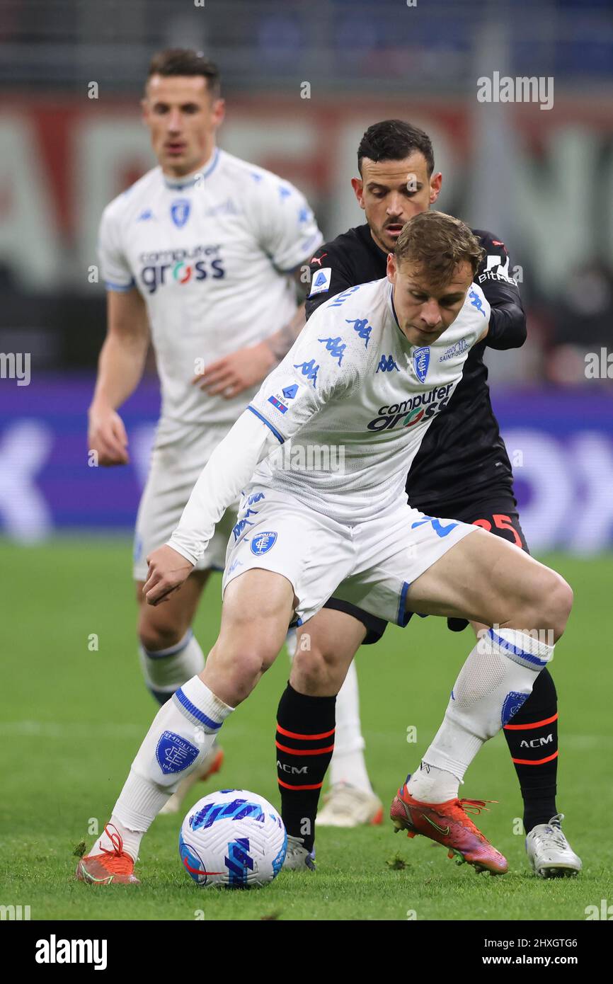Milan, Italy, 12th March 2022. Szymon Zurkowski of Empoli FC shields ...