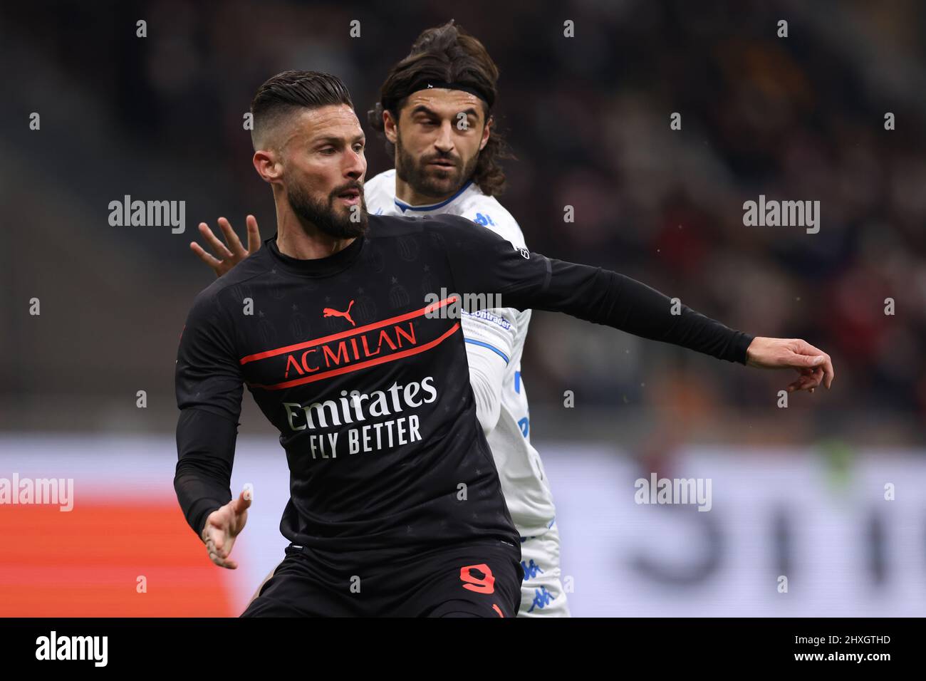 Milan, Italy, 12th March 2022. Sebastiano Luperto of Empoli FC tussles ...