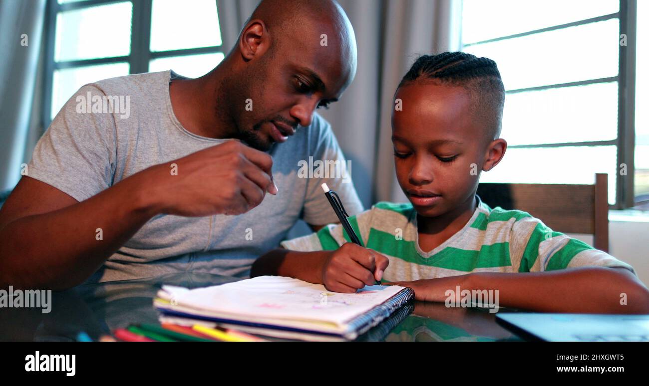 African American father tutoring little boy son Stock Photo - Alamy
