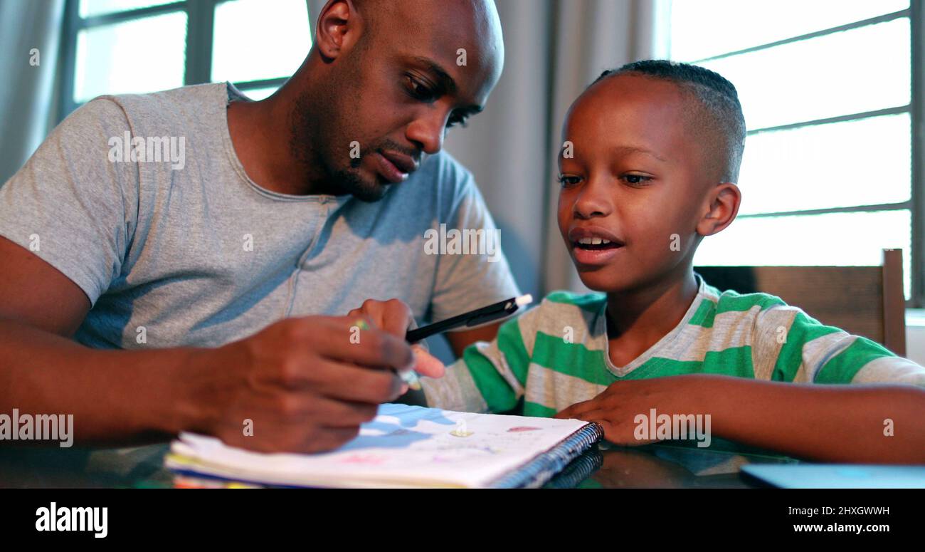 African American father tutoring little boy son Stock Photo - Alamy