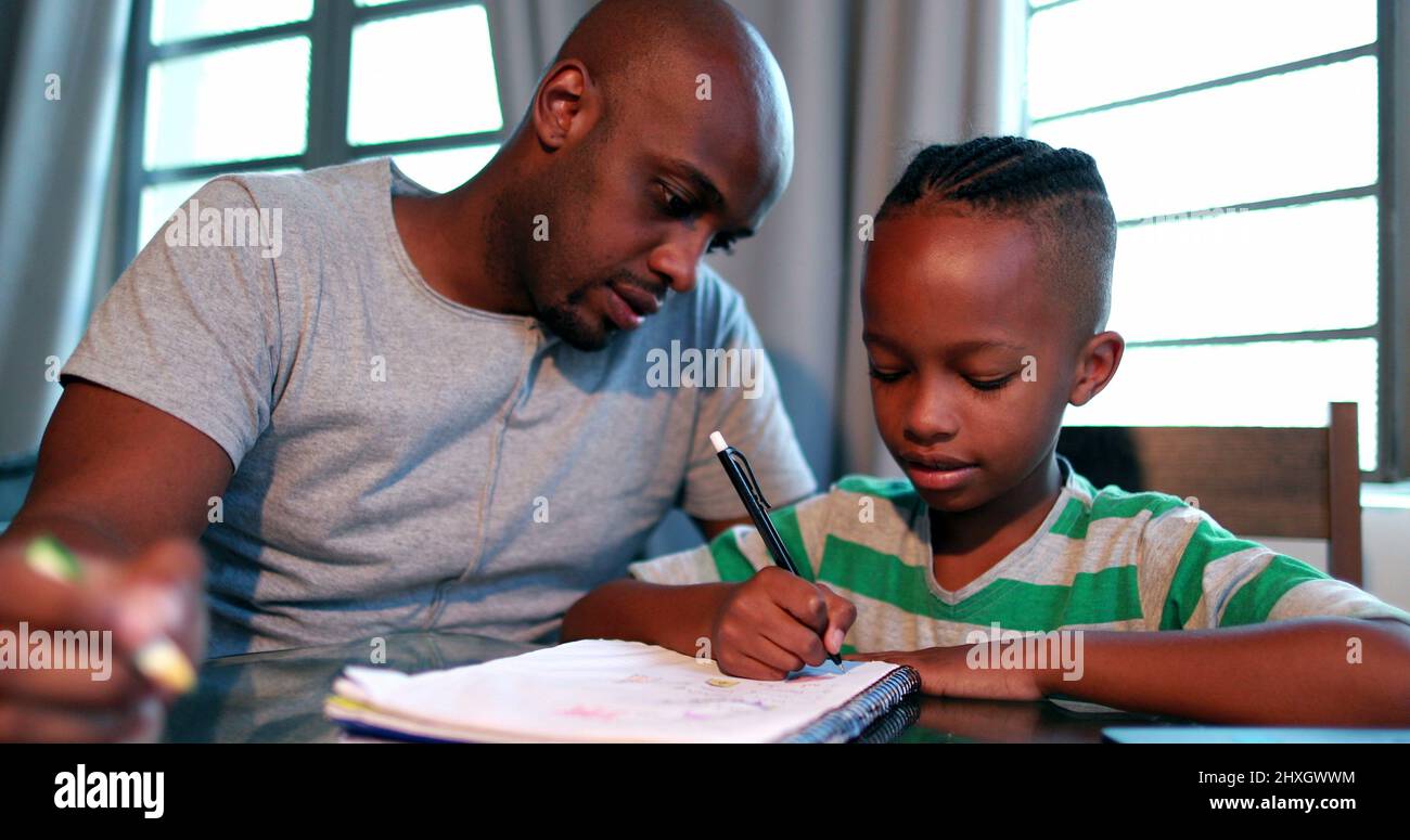 African American father tutoring little boy son Stock Photo - Alamy