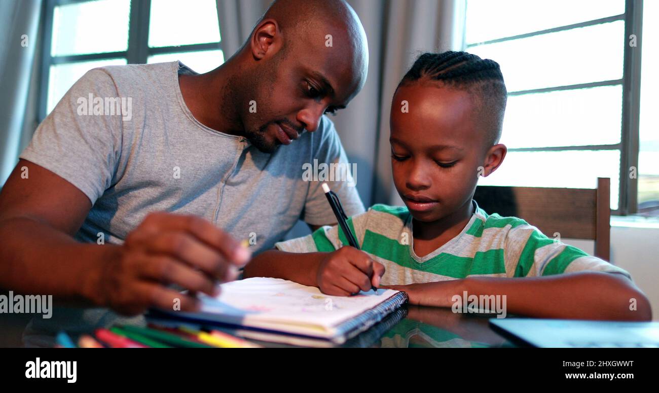 African American father tutoring little boy son Stock Photo - Alamy