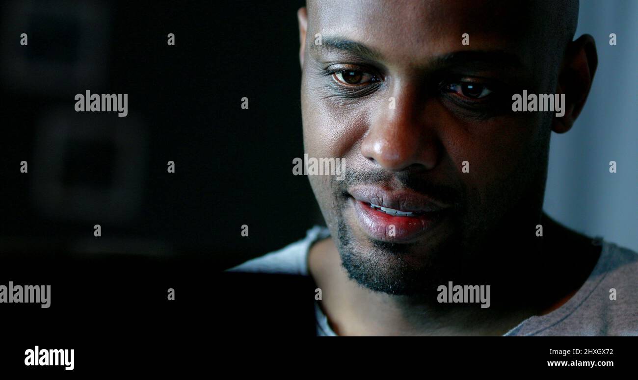 Close-up black man face looking at computer screen at night Stock Photo ...