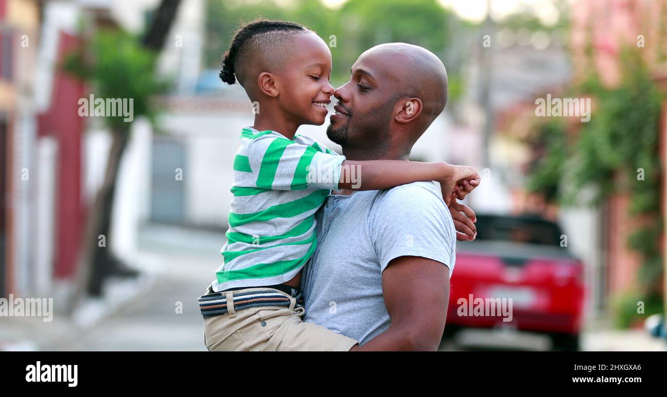 Father and son doing eskimo kiss. African black dad and child bonding ...