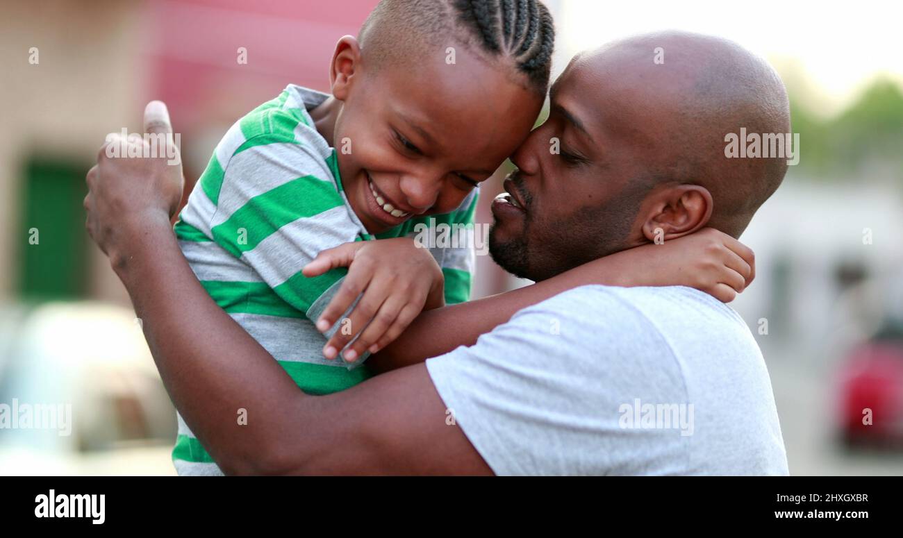 Father and son love care and affection. African dad cuddling with child ...