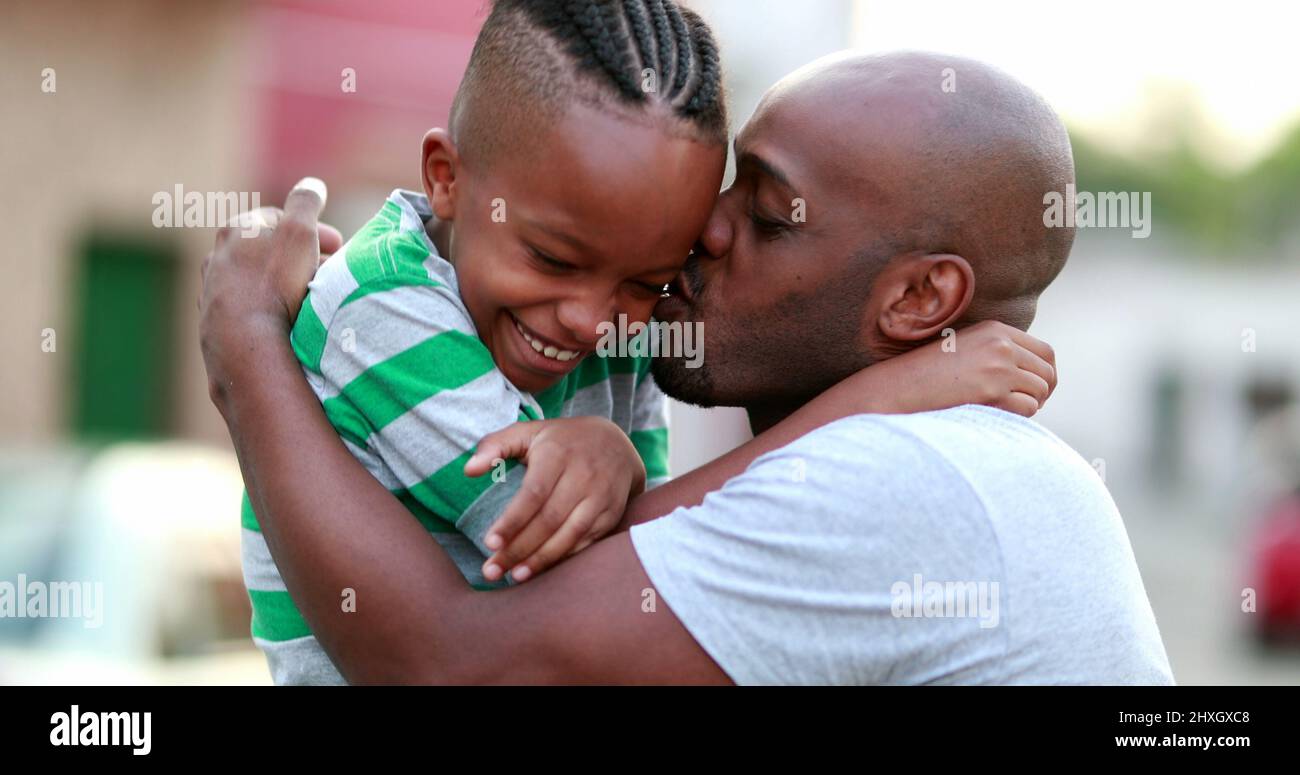 Father and son love care and affection. African dad cuddling with child ...