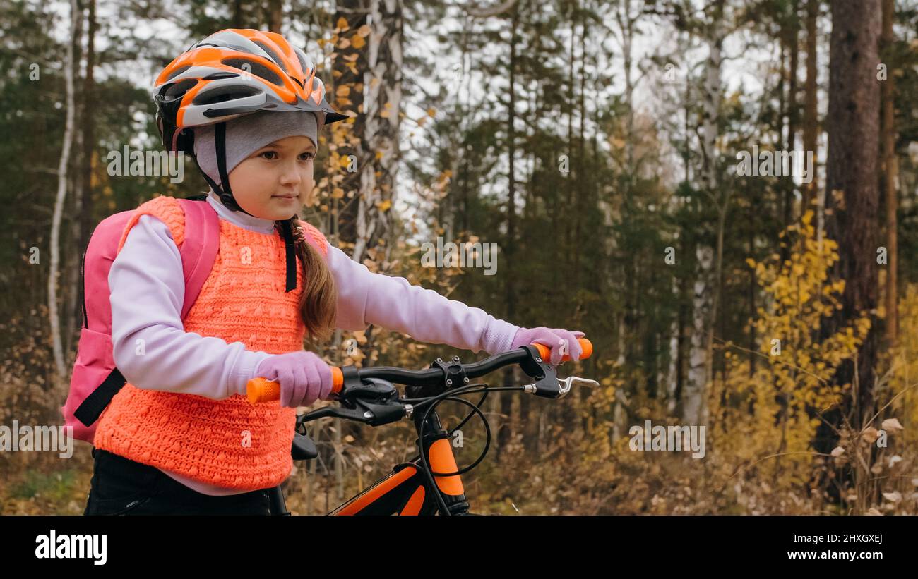 One caucasian children walk with bike in autumn park. Little girl ...