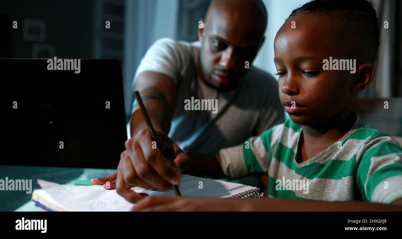 Father multi-tasking using computer laptop at home. Candid authentic ...