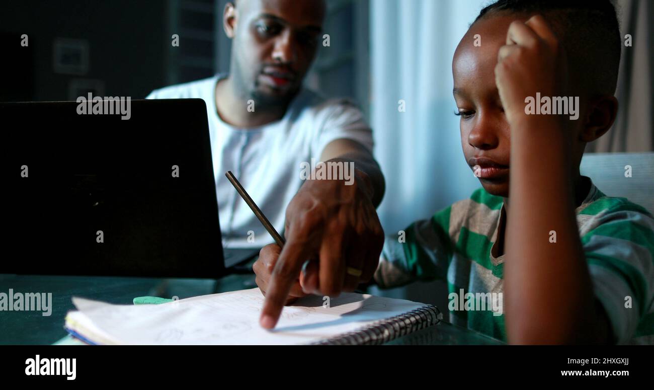 Father multi-tasking using computer laptop at home. Candid authentic ...