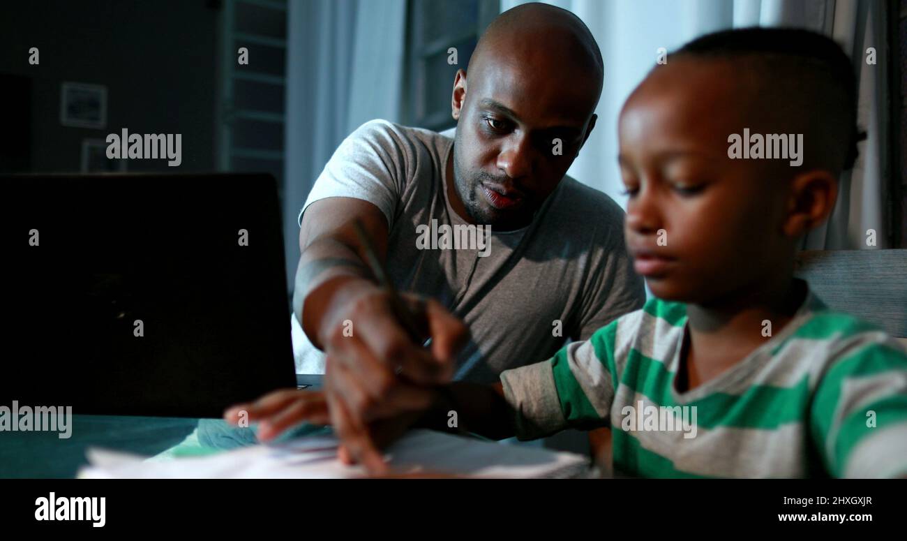 Father multi-tasking using computer laptop at home. Candid authentic ...