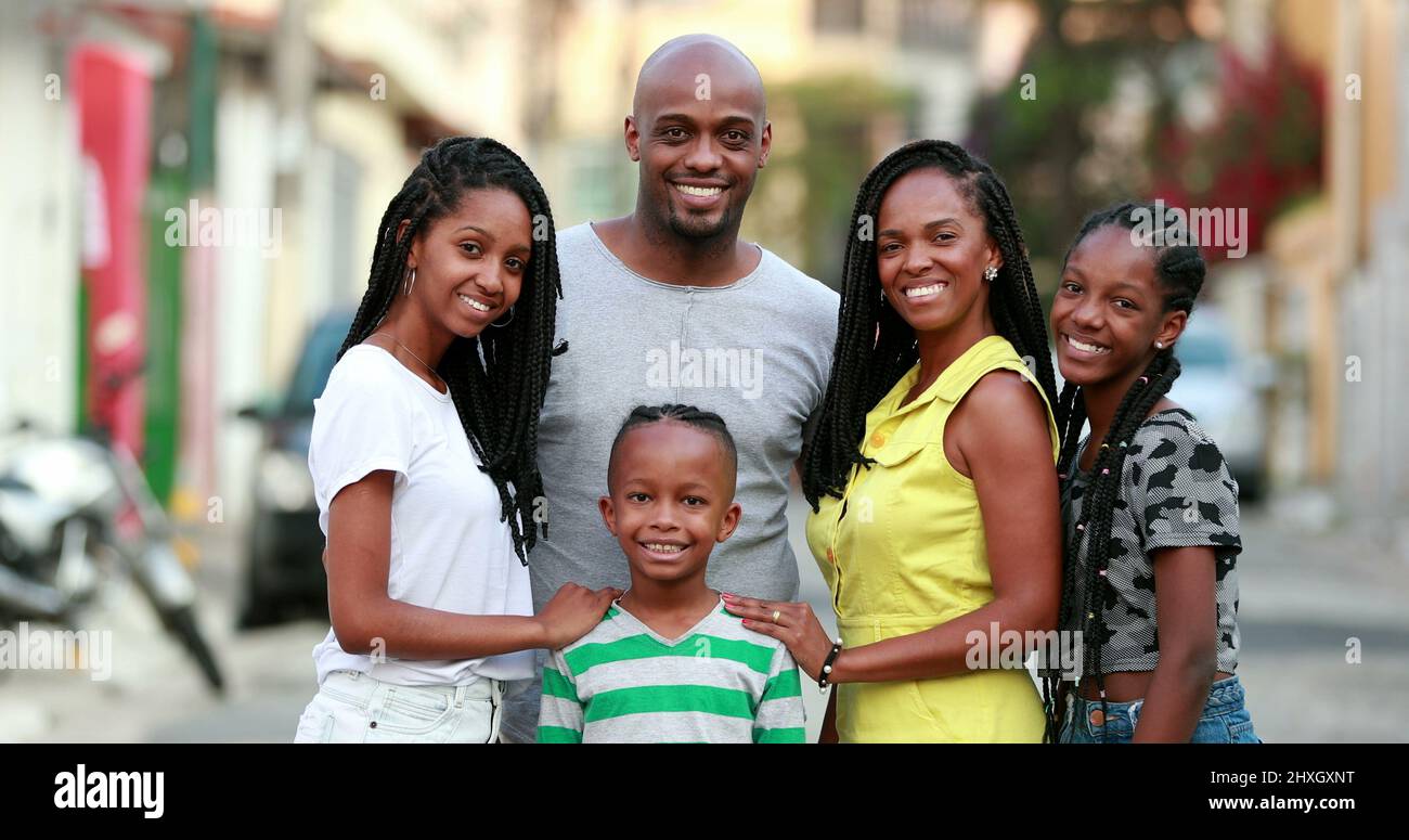 Happy African family portrait standing for photo outside. Cheerful ...