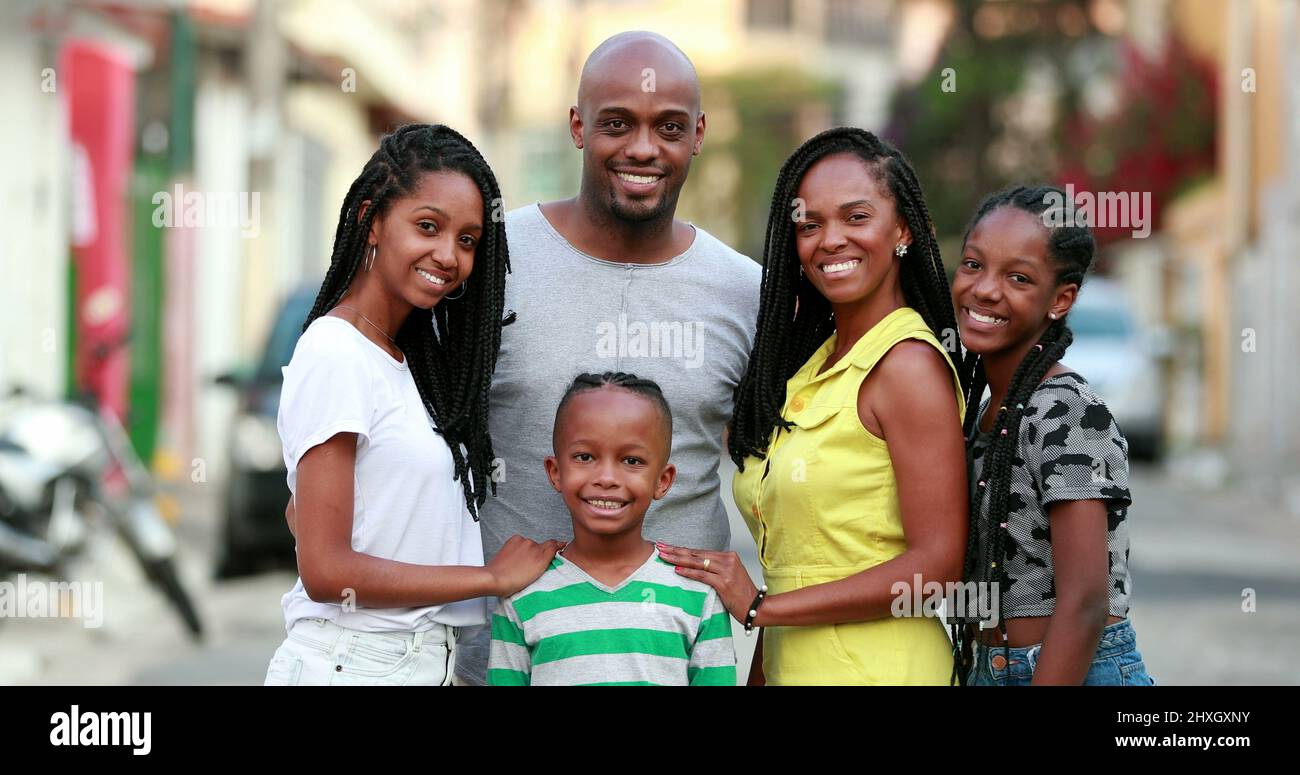 Happy African family portrait standing for photo outside. Cheerful ...