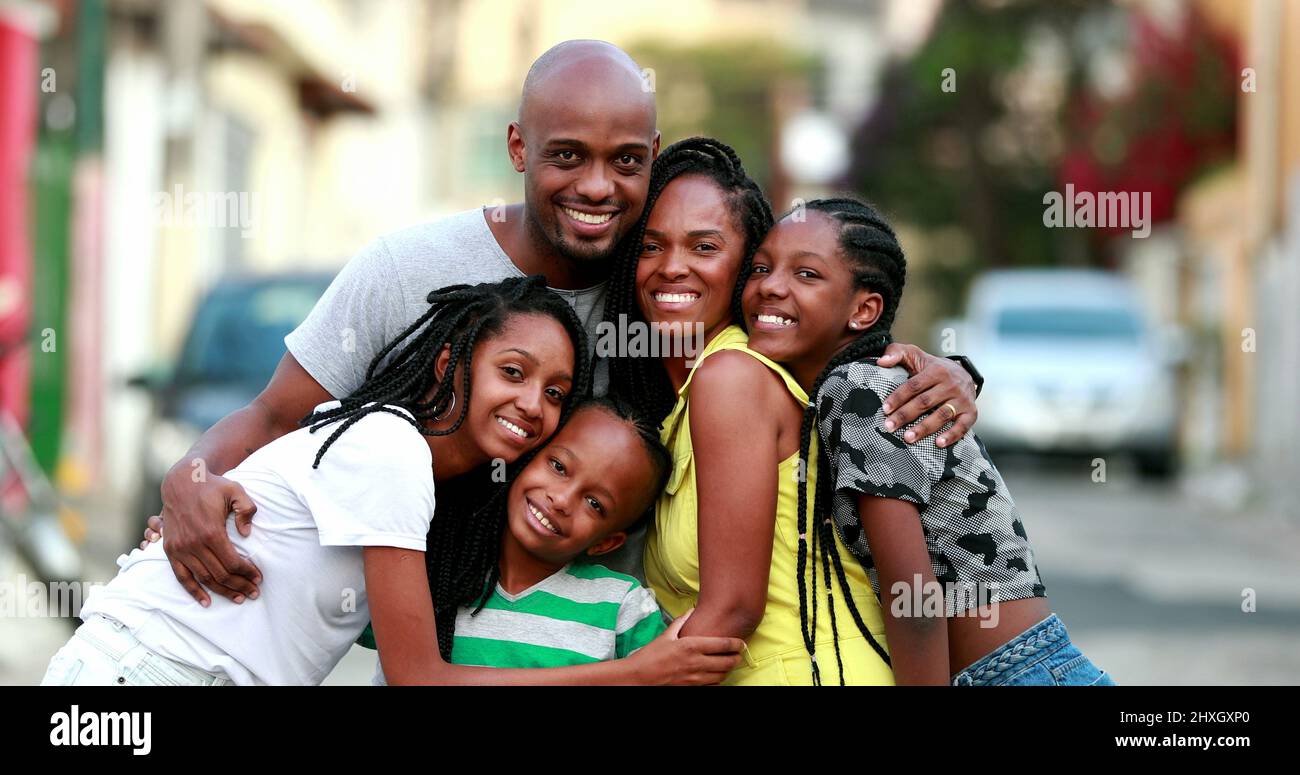 Happy African family portrait standing for photo outside. Cheerful ...