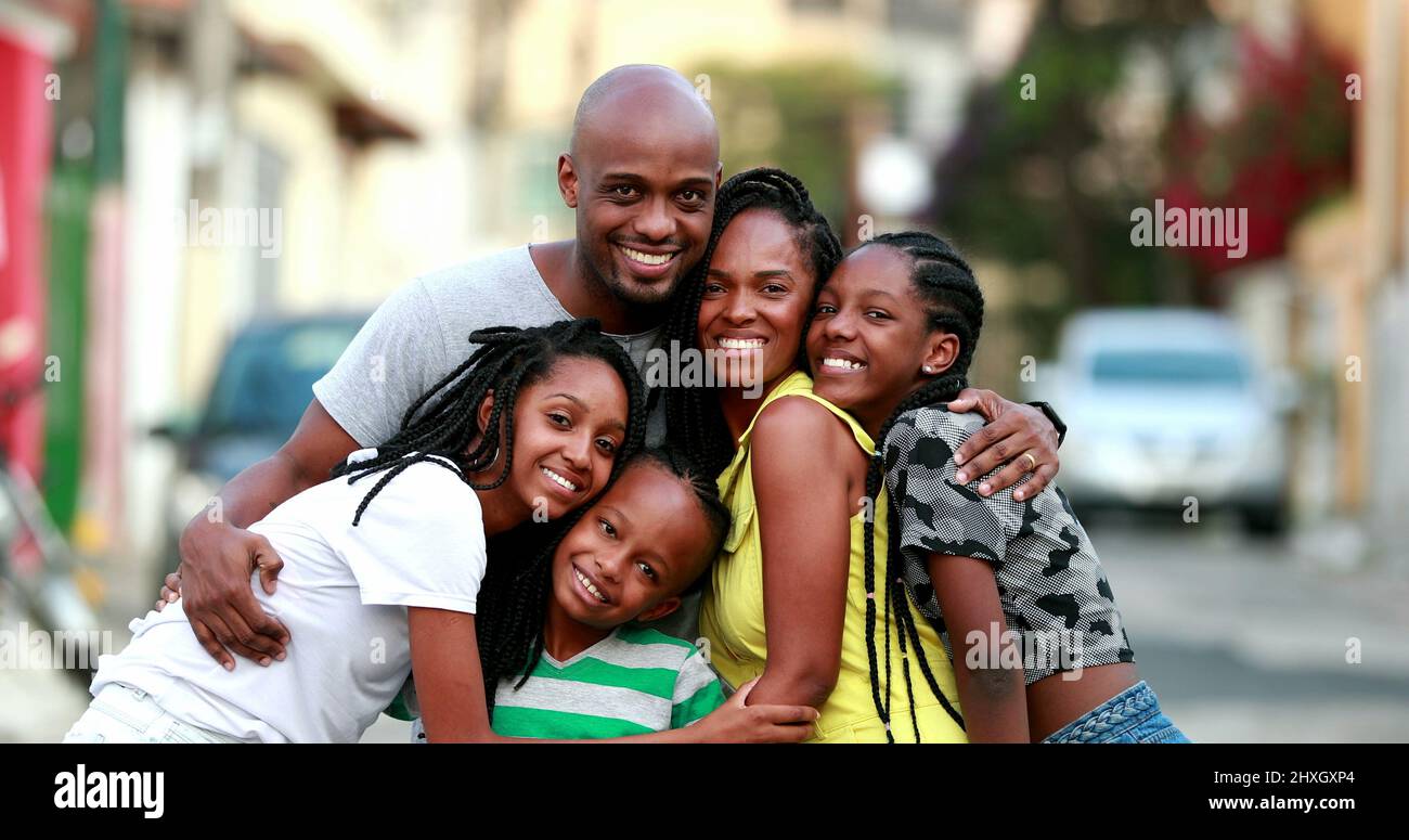 Happy African family portrait standing for photo outside. Cheerful ...