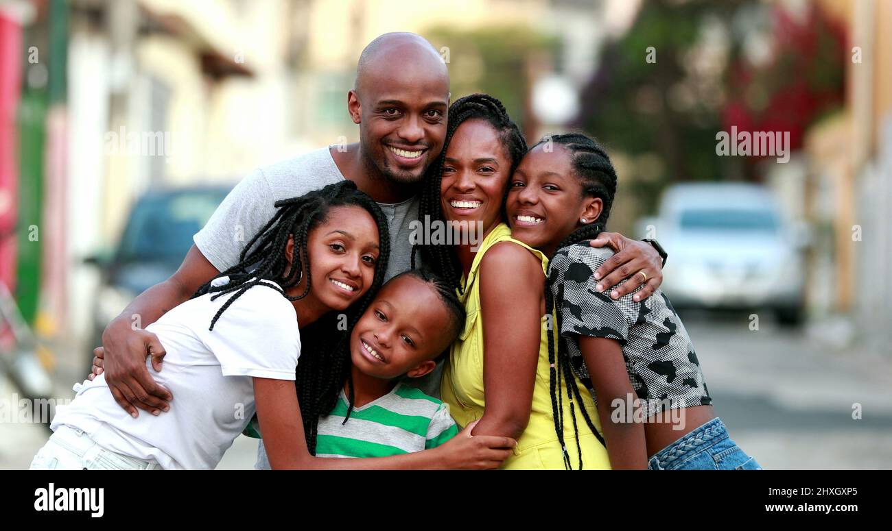 Happy African family portrait standing for photo outside. Cheerful ...