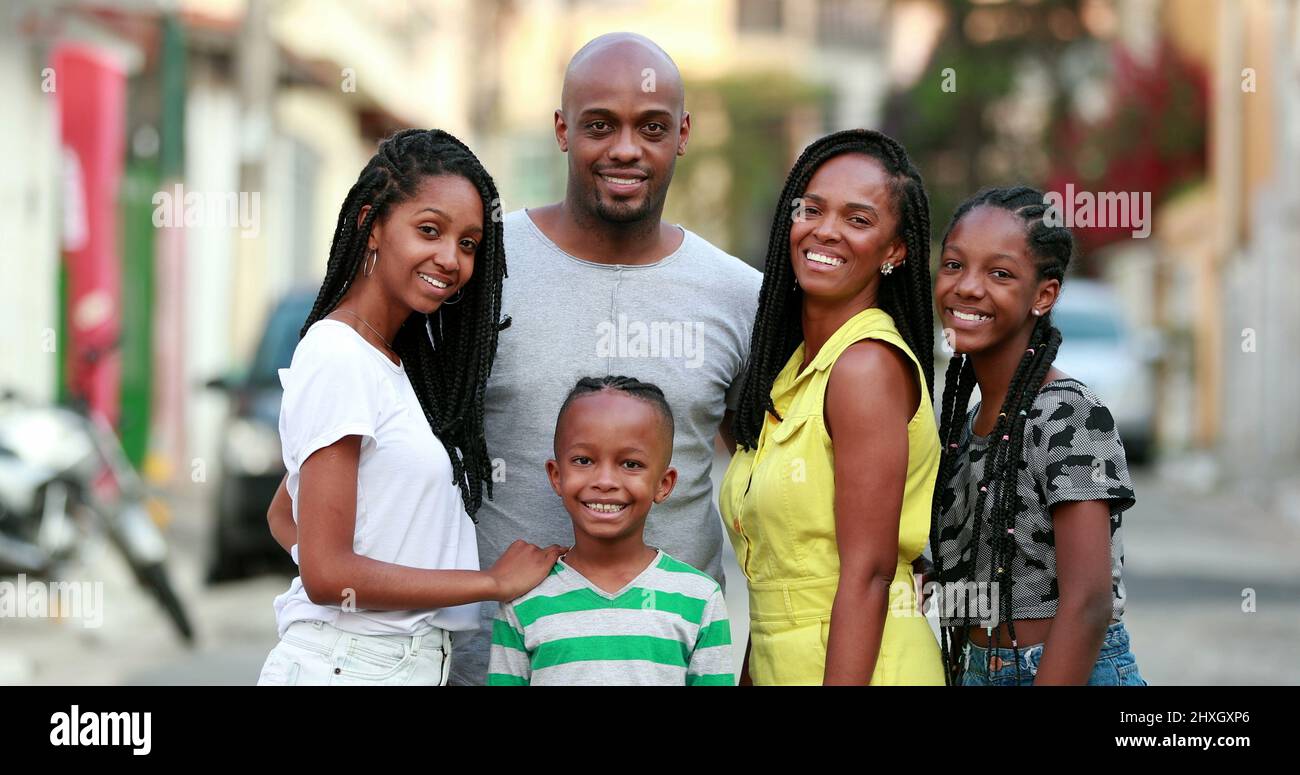 Happy African family portrait standing for photo outside. Cheerful ...