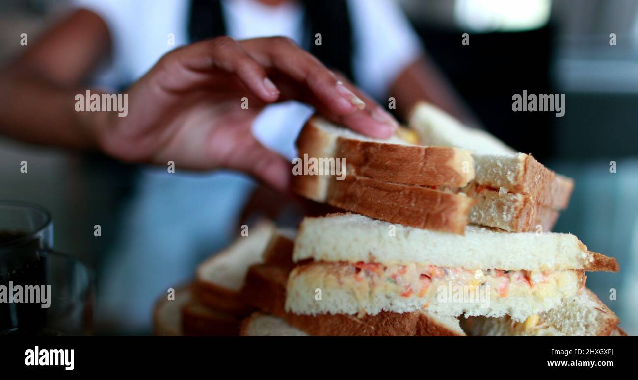 Hands grabbing sandwich. Hand taking caloric food Stock Photo - Alamy