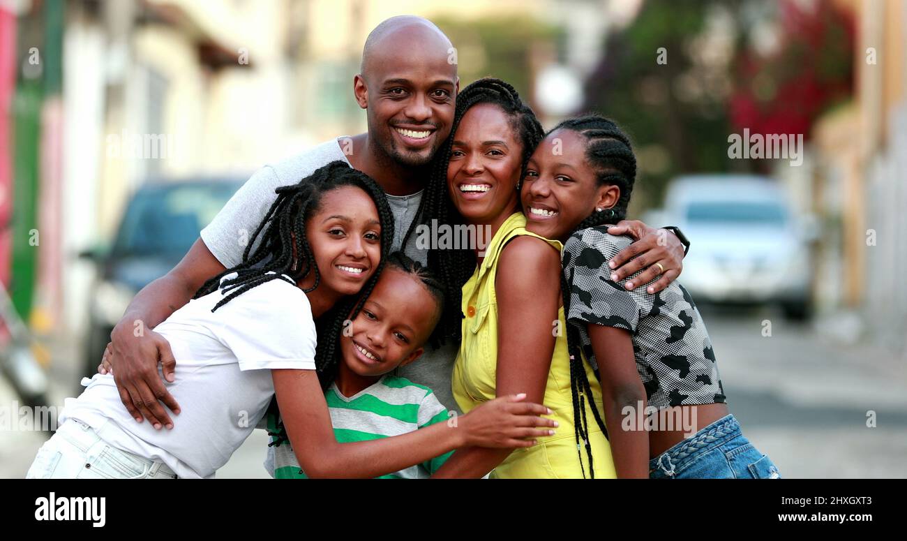 Happy African family portrait standing for photo outside. Cheerful ...