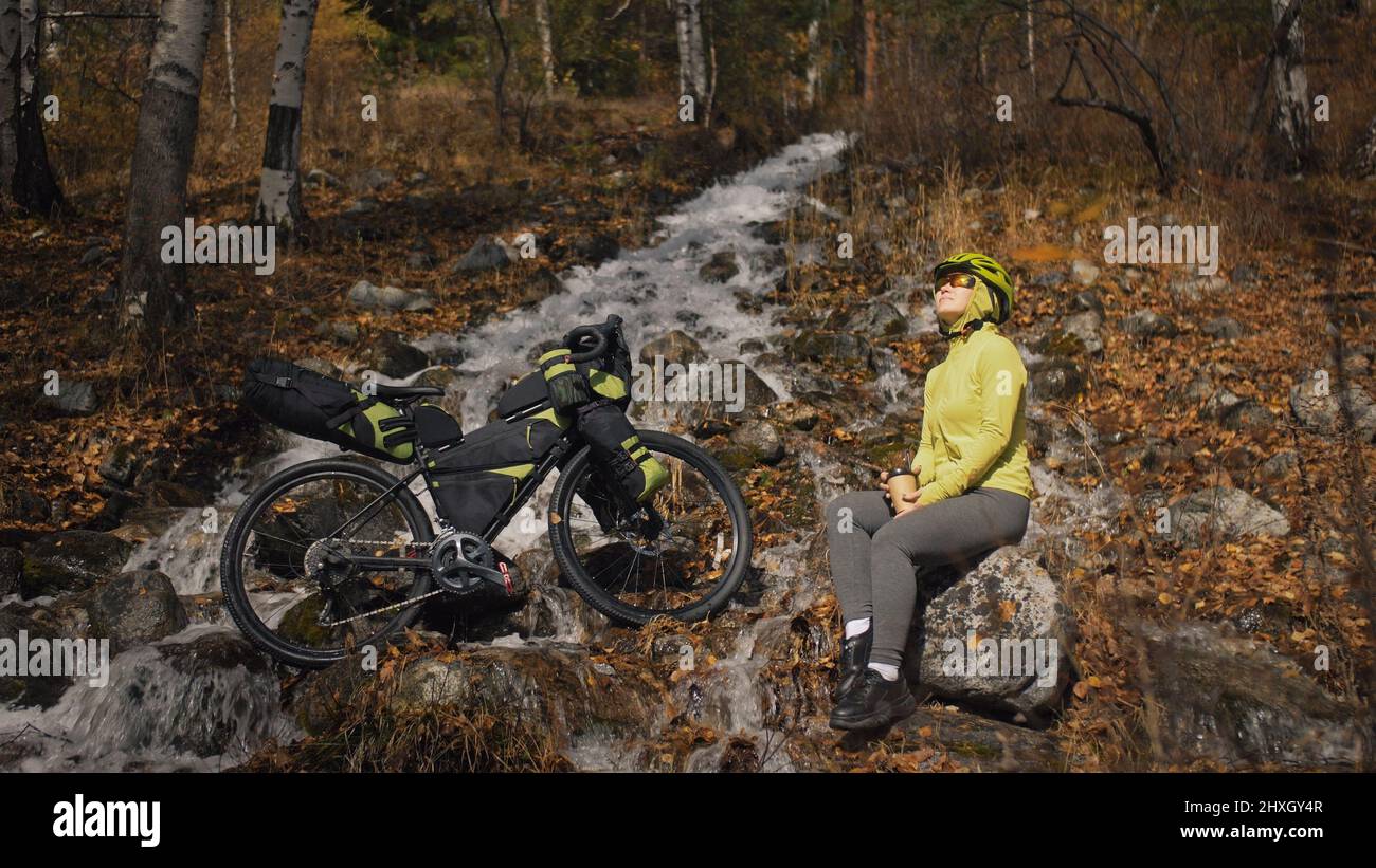The woman travel on mixed terrain cycle touring with bikepacking. The ...