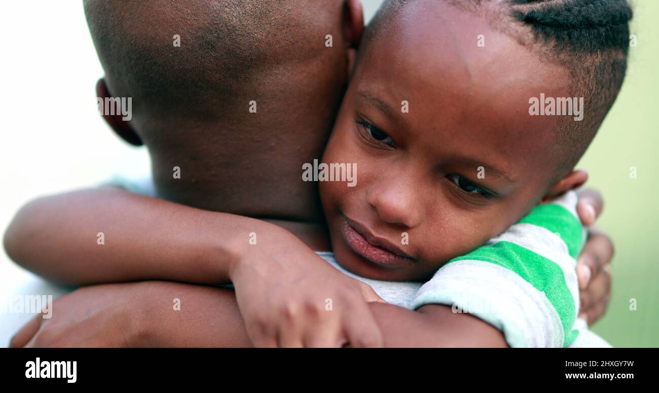 Son hugging father. African kid embracing dad, candid authentic love ...
