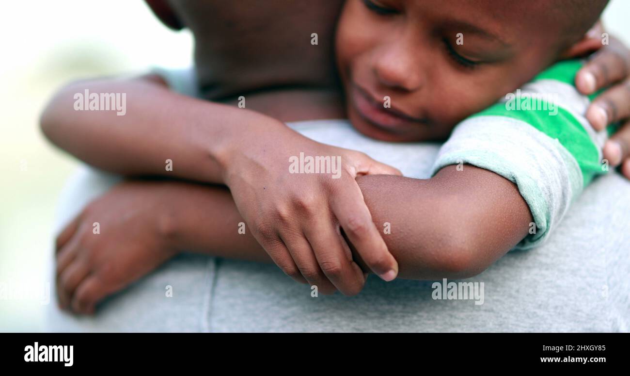 Son hugging father. African kid embracing dad, candid authentic love ...