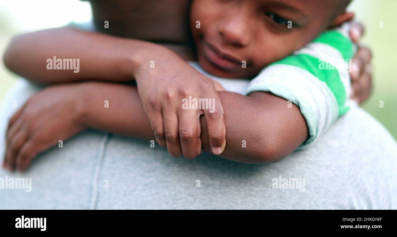 Son hugging father. African kid embracing dad, candid authentic love ...