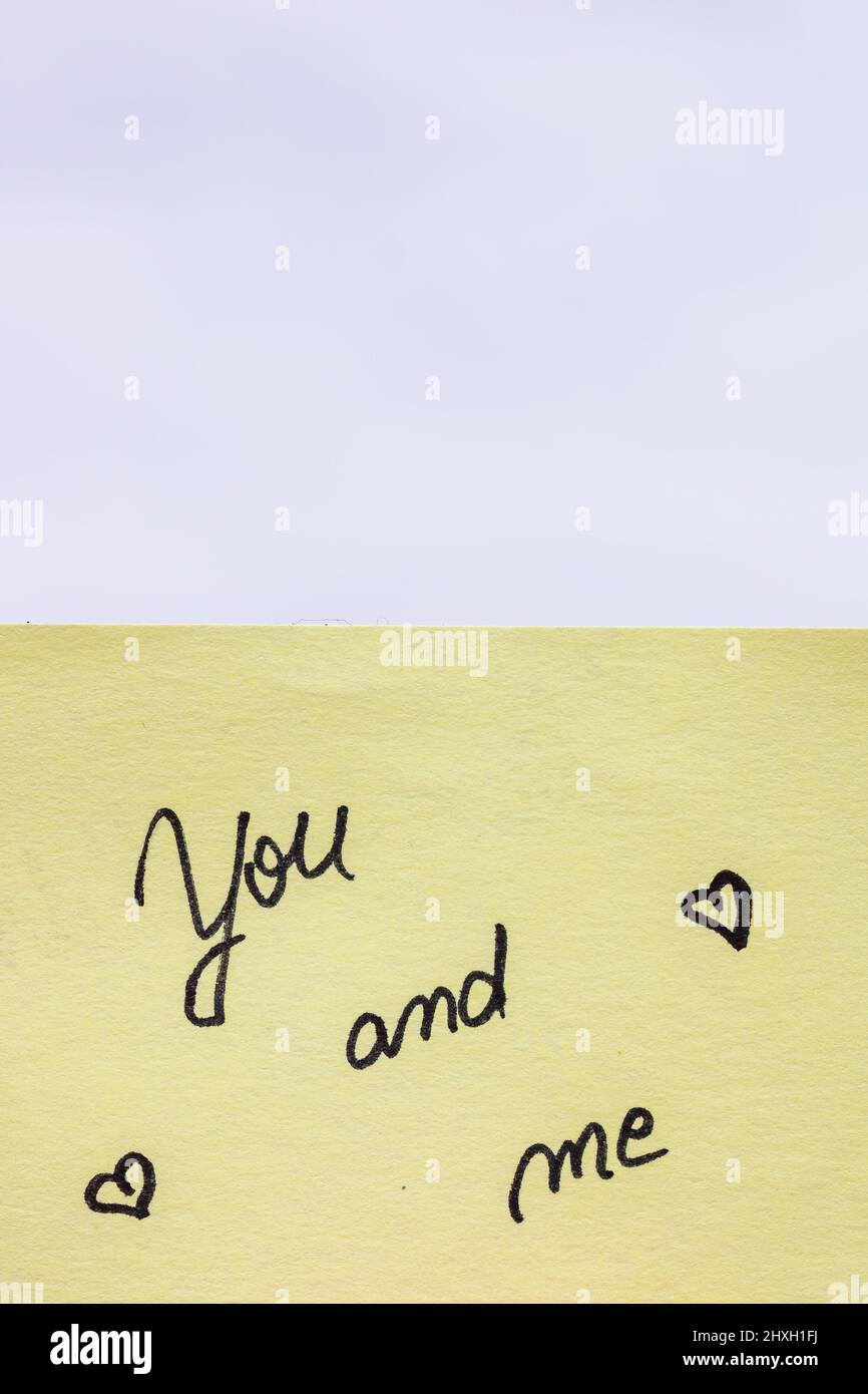 You and me handwriting text close up isolated on yellow paper with copy ...