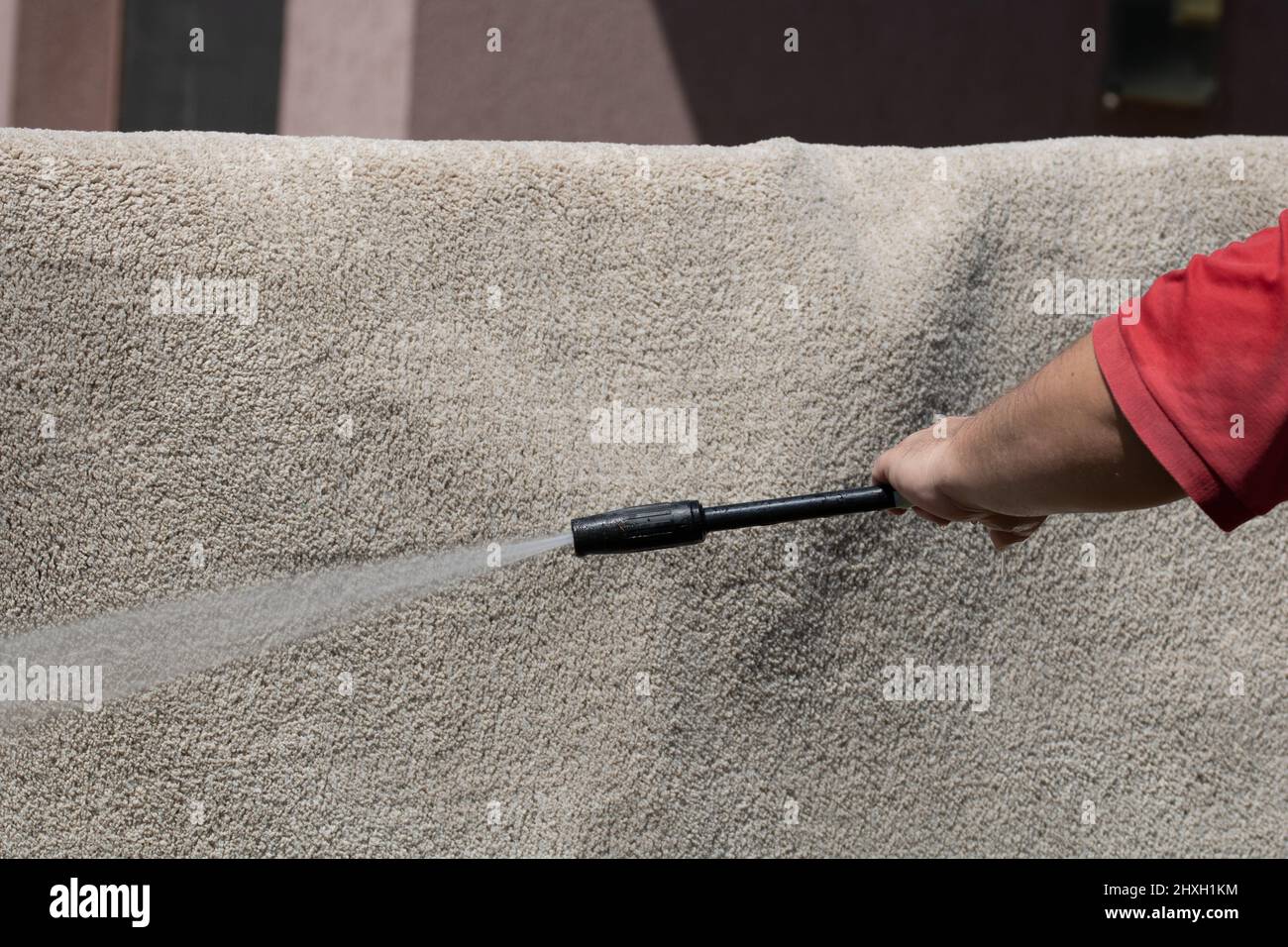 Washing carpets with high pressure washer. Cleaning the carpet with a ...