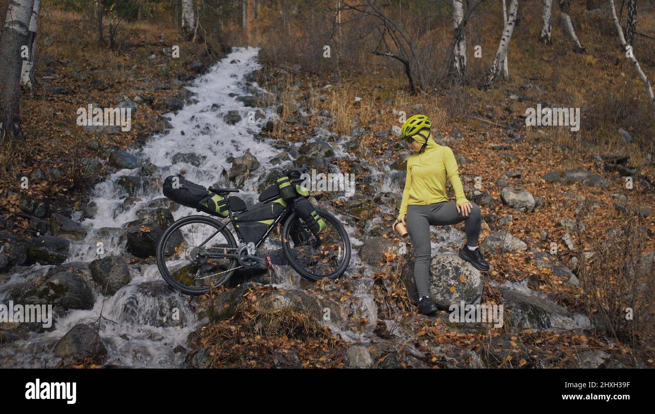 The woman travel on mixed terrain cycle touring with bikepacking. The ...