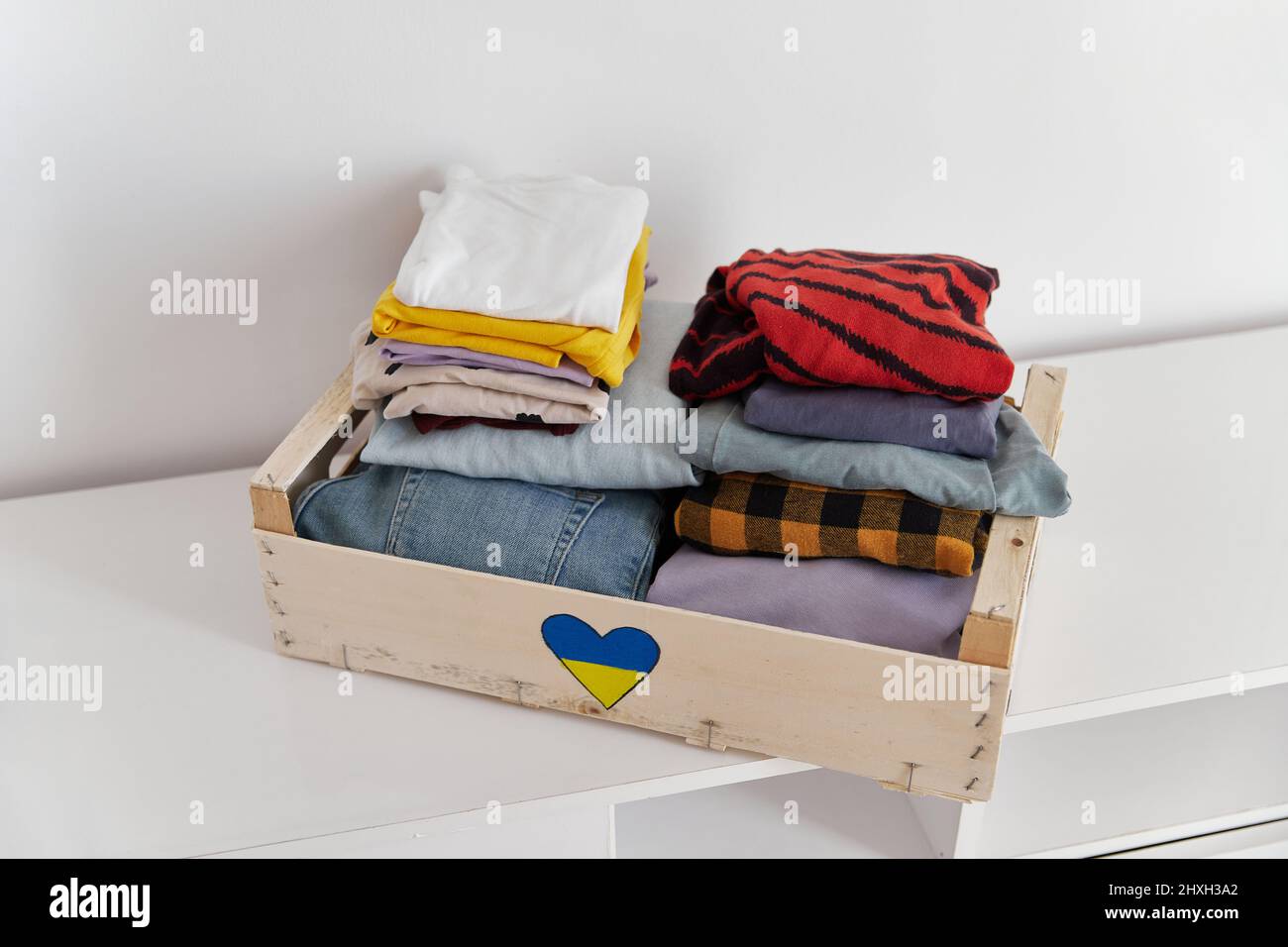 Help volunteering donation concept. Donation box full of clothes at ...