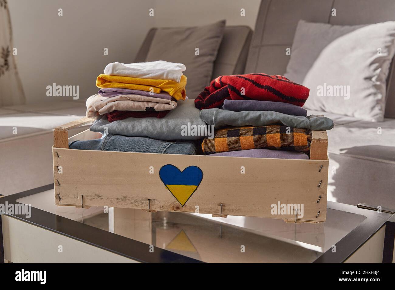 Help volunteering donation concept. Donation box full of clothes at ...