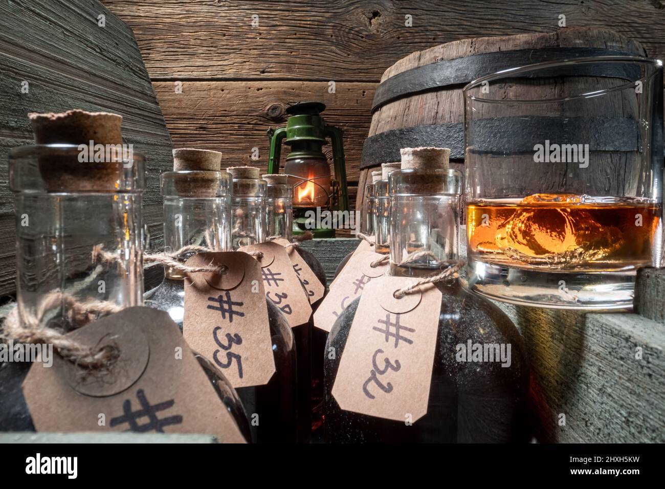 Golden and old whisky stored in the old distillery. Whiskey with ice in ...