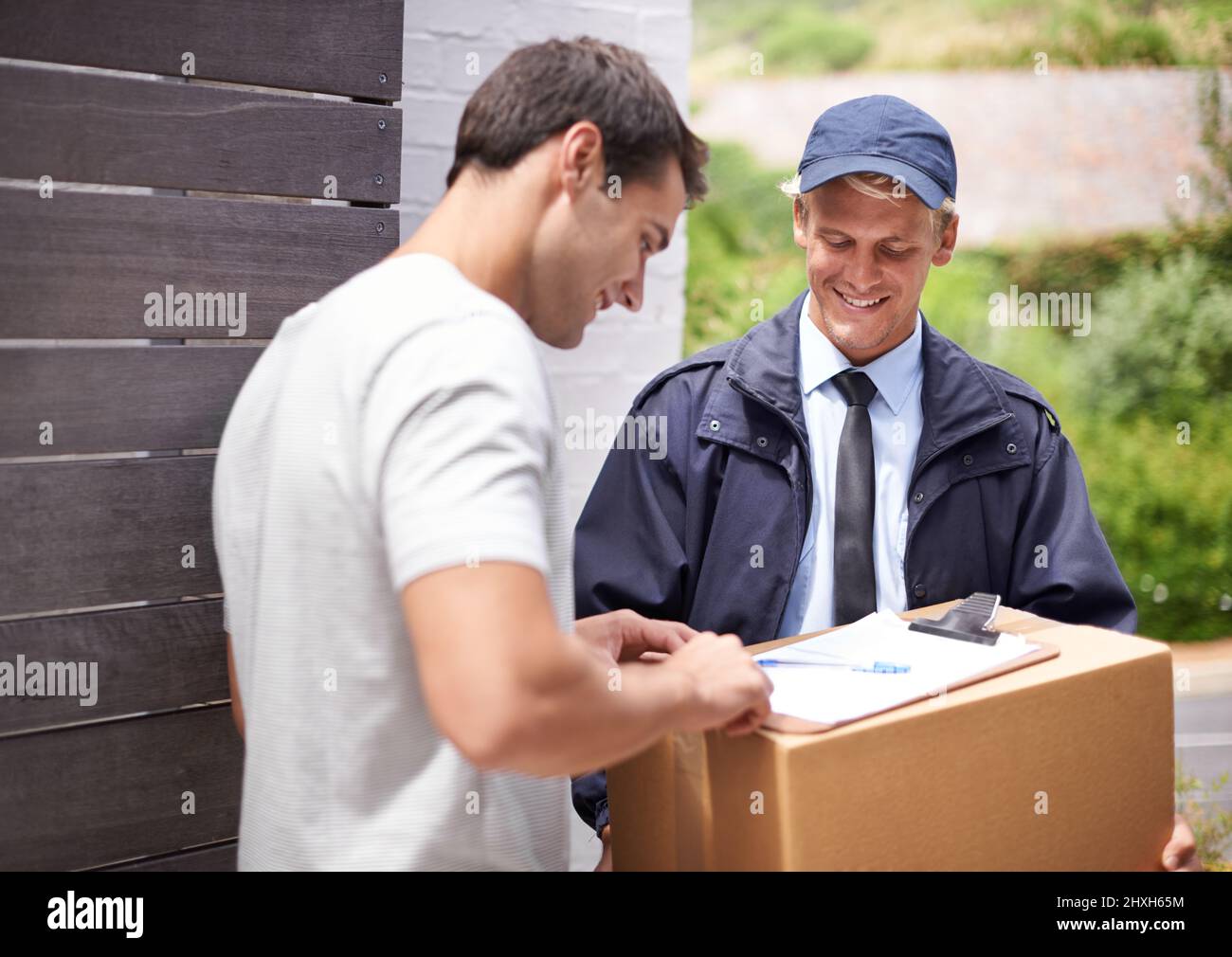 My parcel finally came. Shot of a young man receiving a parcel from the ...