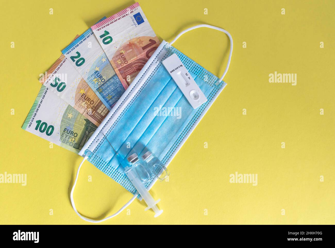 Money (Euro currency banknotes) with medical masks, antigen test ...