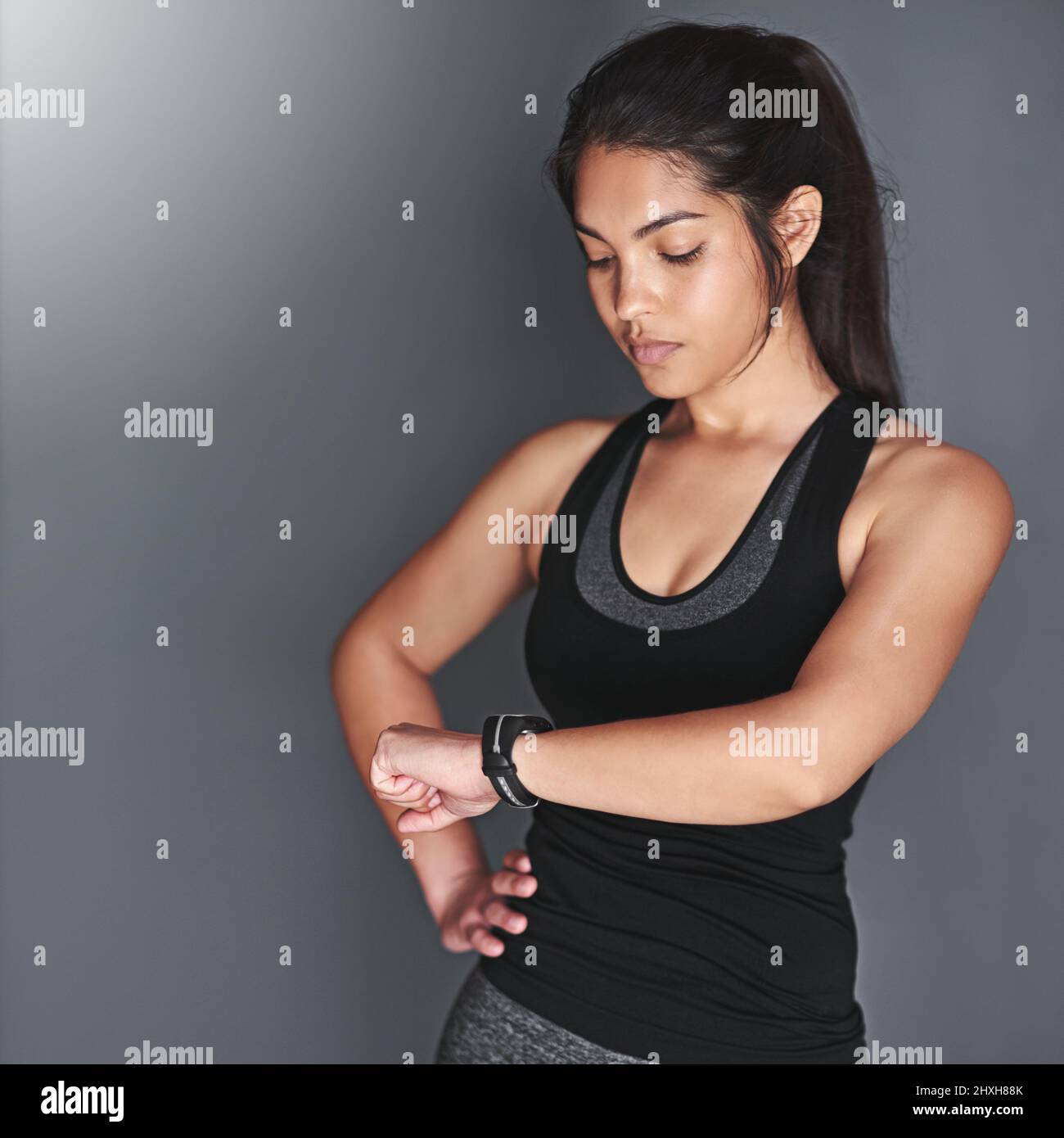 Getting more fit by the day. Shot of a fit young woman in sports ...