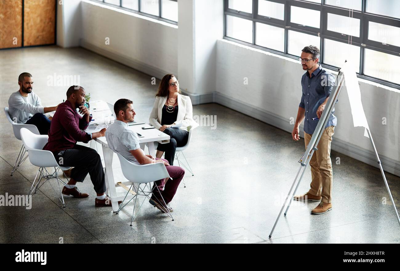 Giving an expert presentation. High angle shot of a group of ...