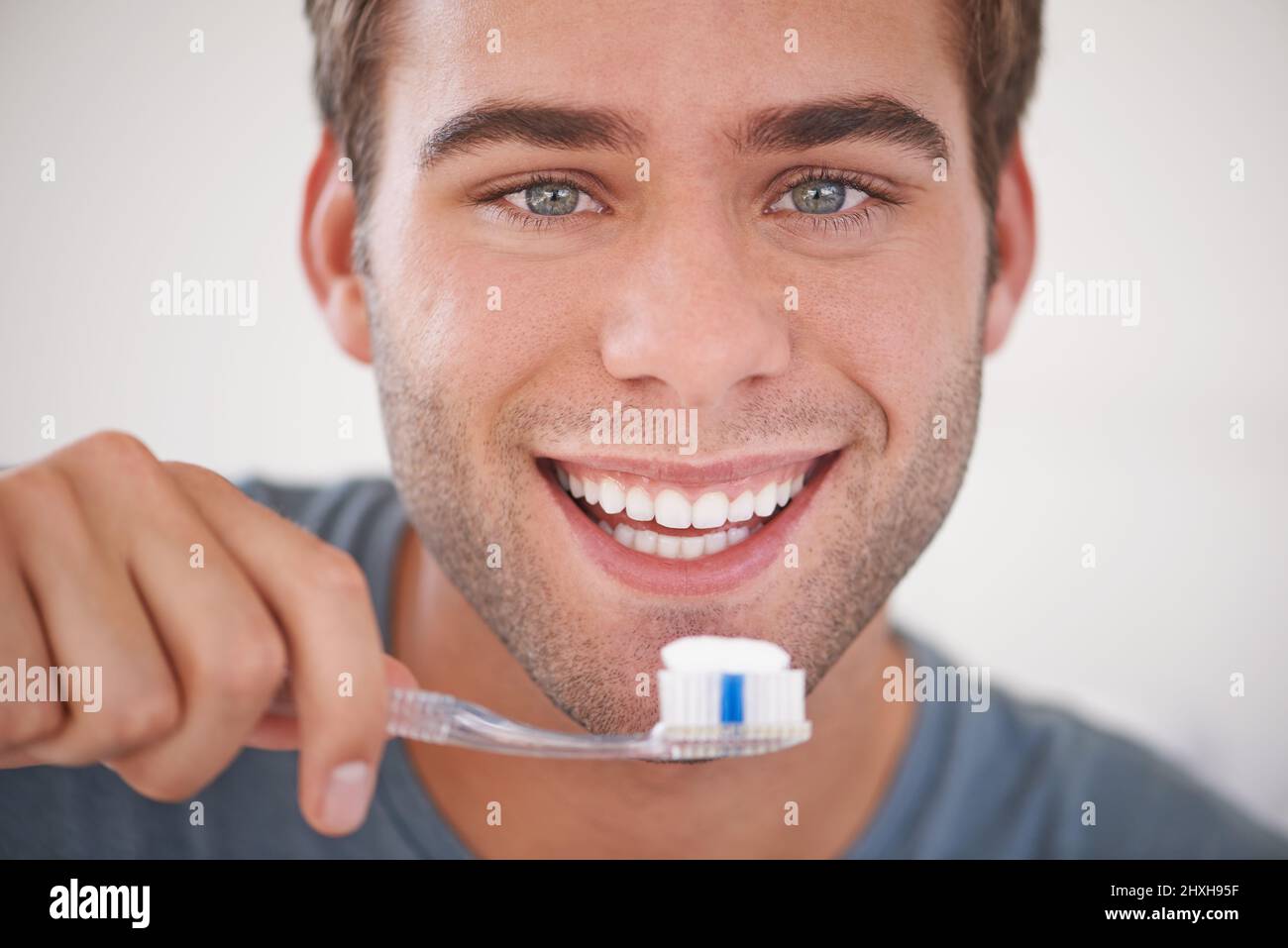 Keeping his teeth sparkly white. Cropped shot of a man brushing his ...