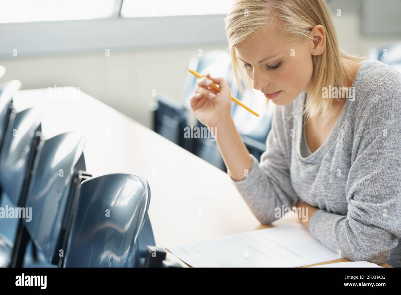 Focused on her studies. A beautiful college student studying in a ...