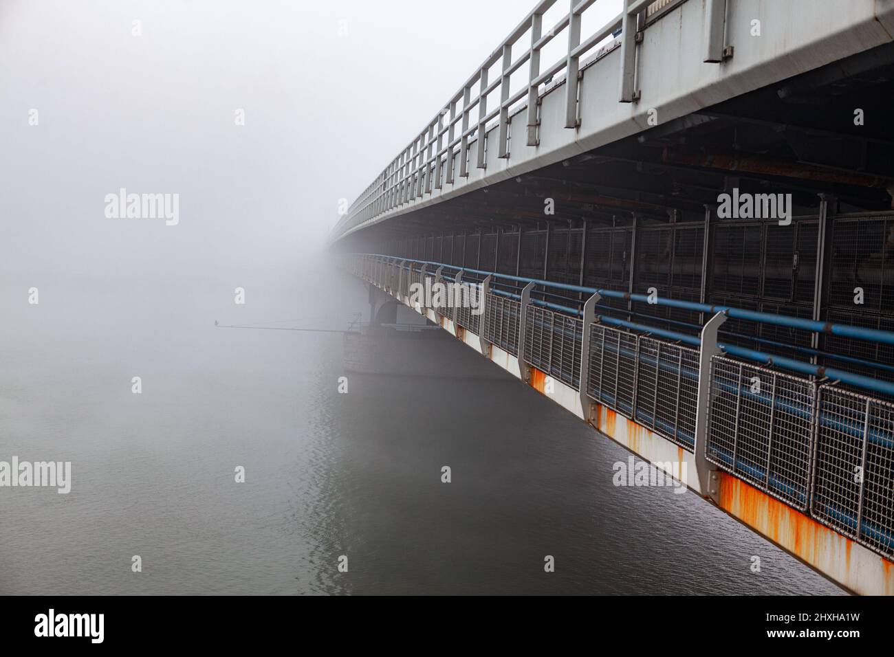 Bridge over the water in haze . Danube River in Foggy Morning ...