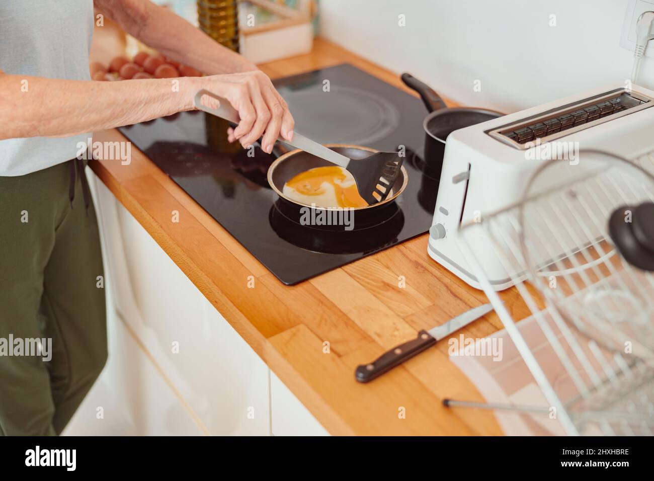 Image of elderly female cooking at kitchen at home Stock Photo - Alamy