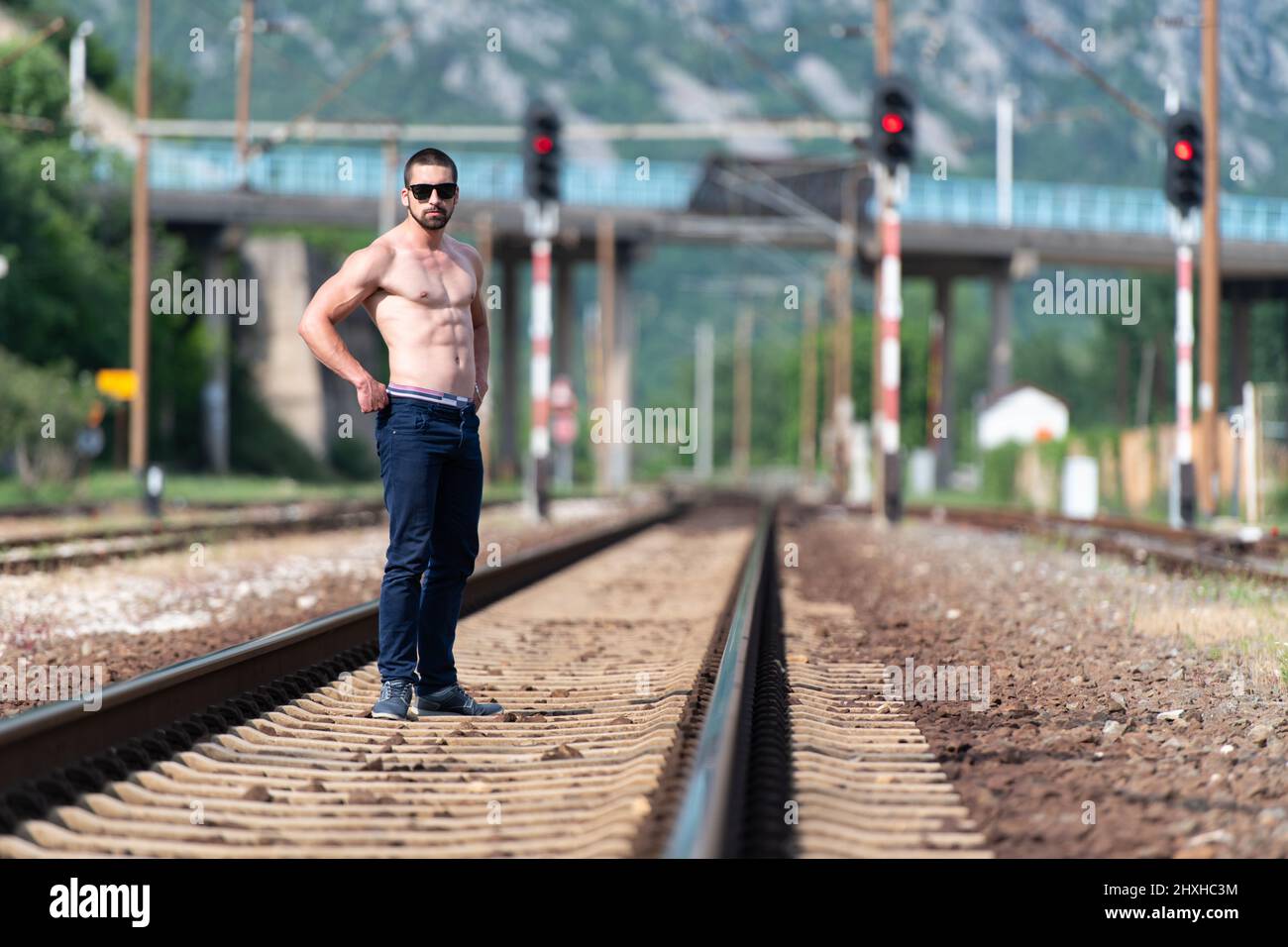 Handsome Beard Man Standing Strong and Posing Outdoors at Railroad From ...